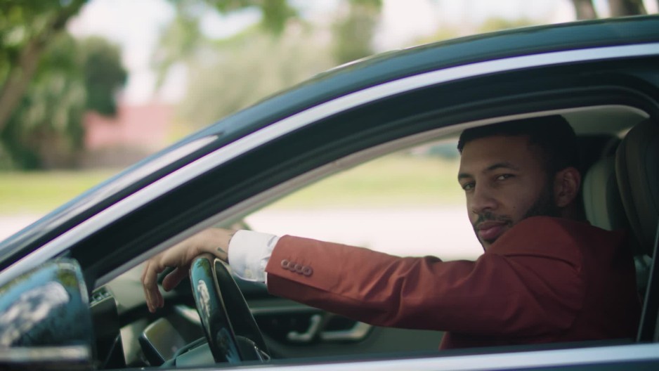 African American male looking at camera while sitting in car | ClipStock