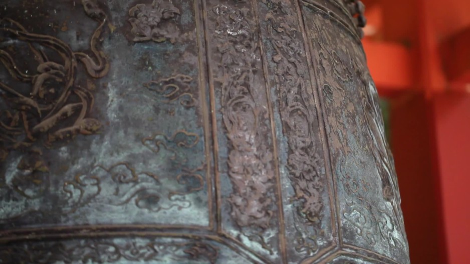 Close up tilt down of swinging bon sho bell in kanetsuki do in Byodo in ...