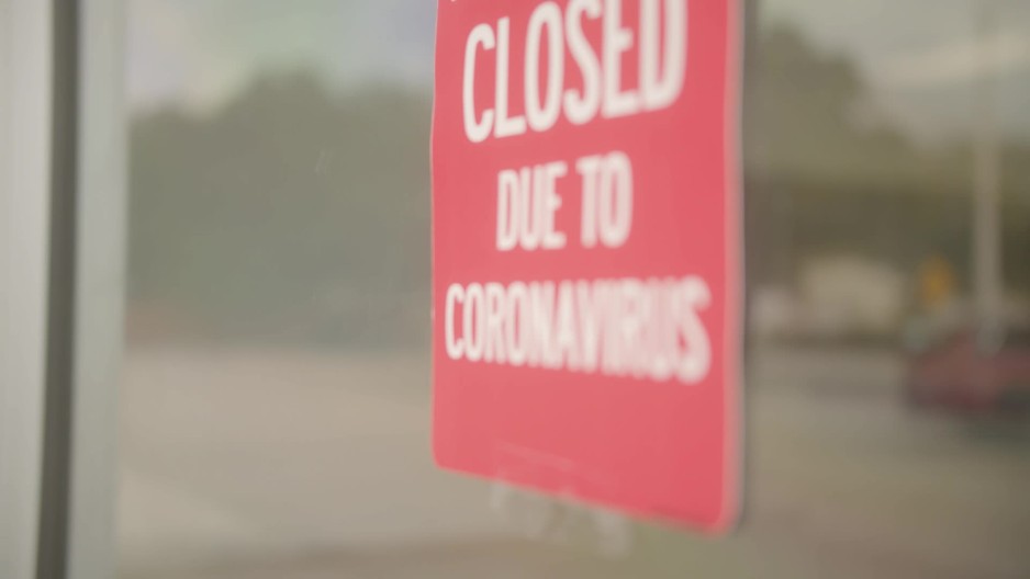 Permanently closed sign hanging from a window | ClipStock