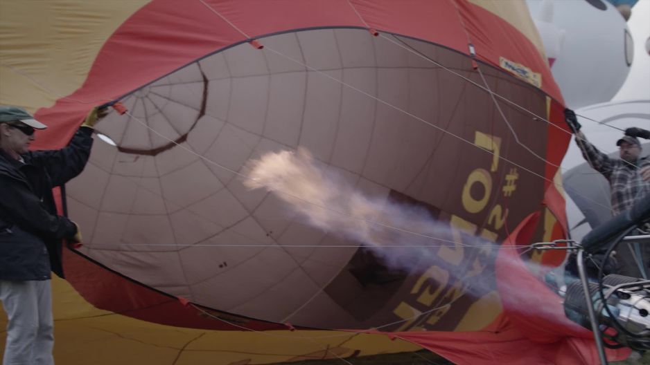 View from beside basket of yellow hot air balloon sideways with one ...