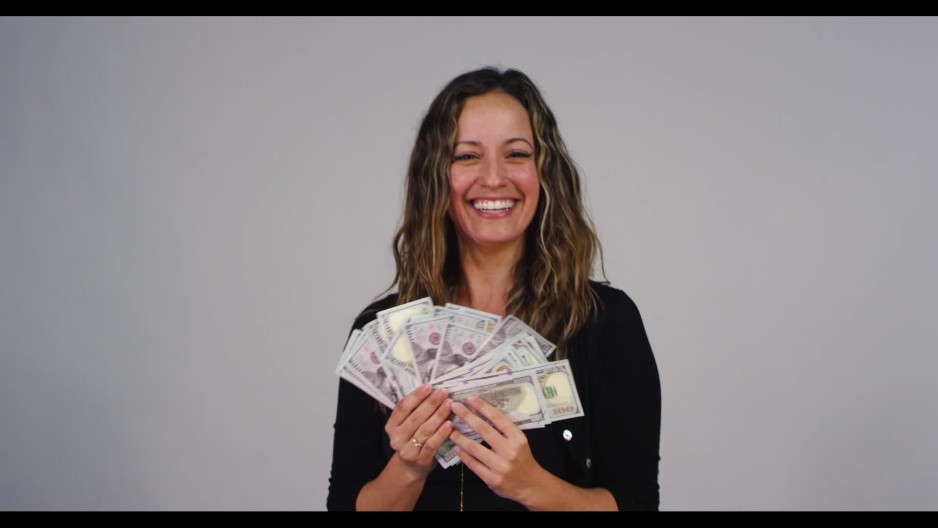 Woman fanning herself with 100 dollars bills - Slow Motion | ClipStock