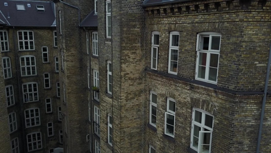Descending into inner courtyard of brick building in Copenhagen | ClipStock