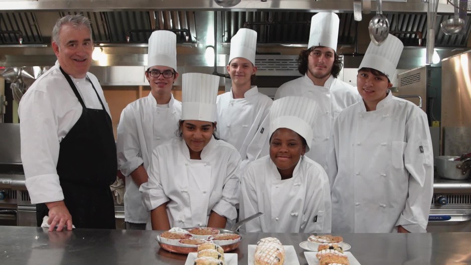 Head Chef with multicultural class of young chefs in training posing ...