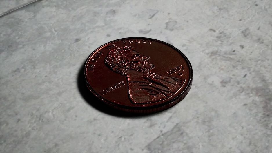 US currency minted coin penny lying flat on grey surface rack focus CGI ...