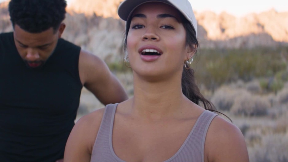 Portrait of pretty tan female smiling catching her breath after ...