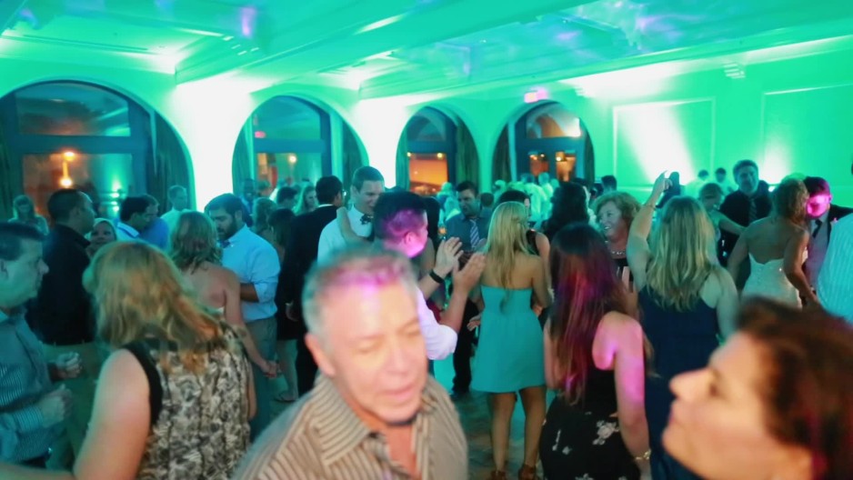 people dancing on crowded dance floor during wedding reception in ...