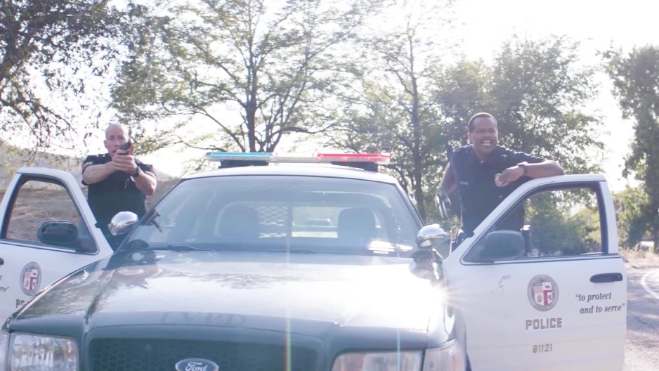 Police officers holding out guns while pulled over on side of the road ...