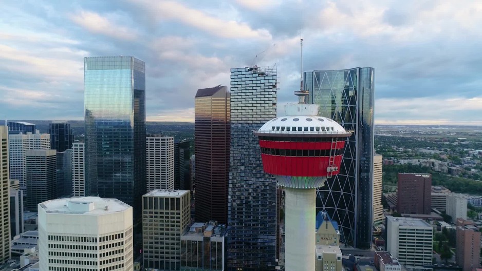 top of Calgary tower with skyscrapers behind it in Downtown Calgary ...