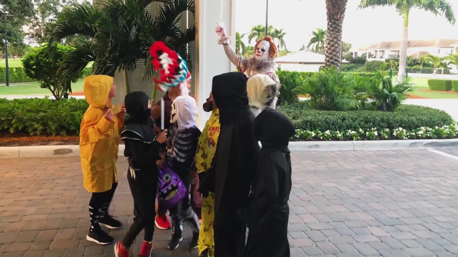 Children in Halloween costumes posing for picture and scared by clown ...