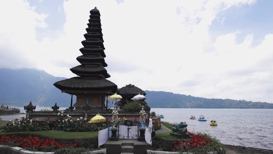 Pagoda towers on Lake Bratan with pedal boats in Pura Ulun Danu Bratan ...