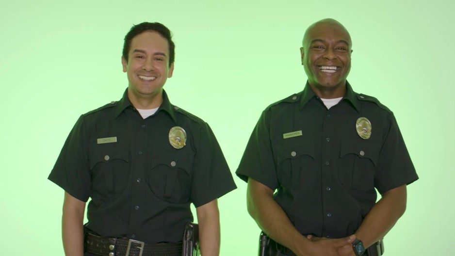 Male police officers standing together and laughing | ClipStock