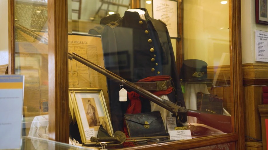 Civil war uniform and artifacts inside display case at museum in ...