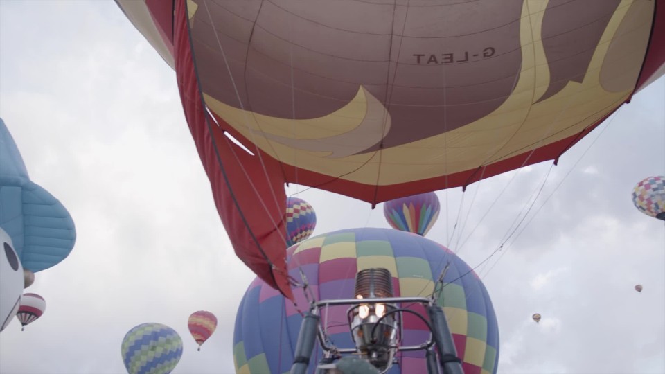 View from beside basket of yellow hot air balloon sideways with one ...